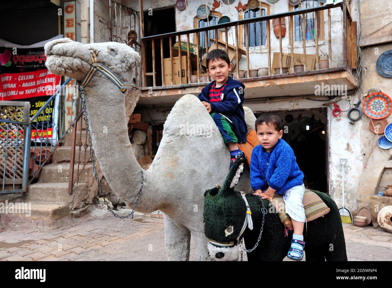 TURKEY. CAPPADOCIA. AVANOS. TURKISH KIDS PLAYING WITH SOME TOY ANIMALS ...