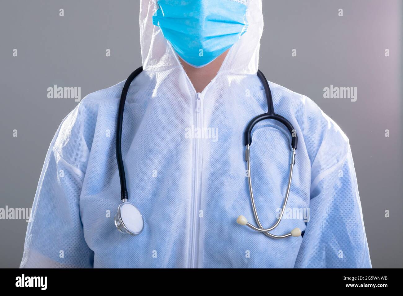 Caucasian female doctor wearing ppe suit, isolated on grey background ...