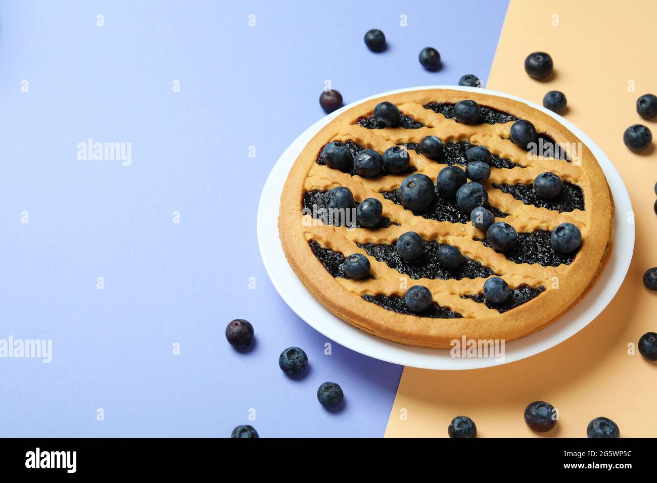 Delicious blueberry pie with berries on two tone background Stock Photo ...