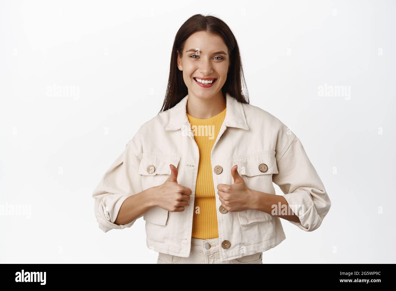 Yes, excellent. Smiling brunette girl showing thumbs up in approval ...
