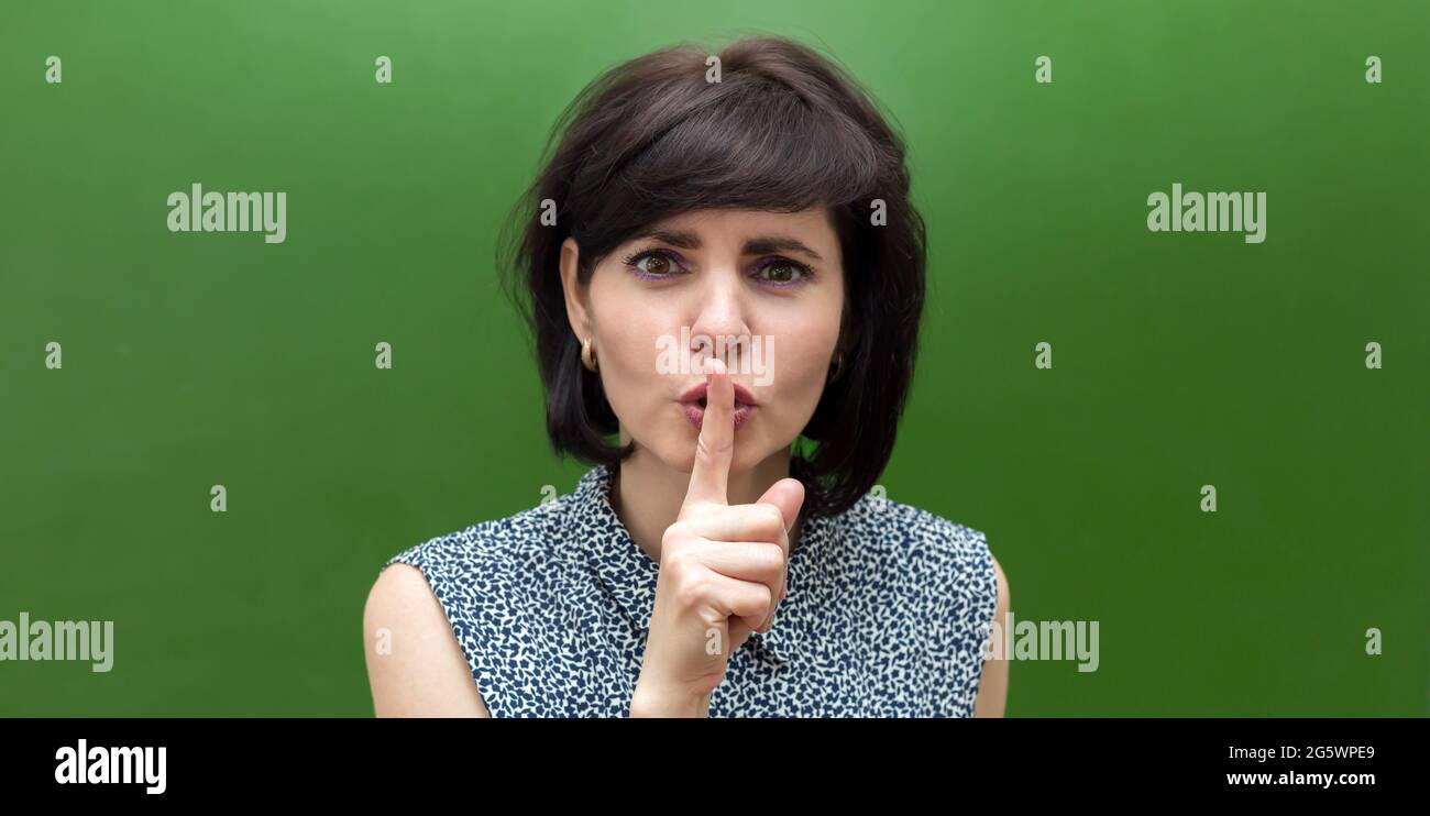 A teacher in school classroom shows silence with a gesture Stock Photo ...
