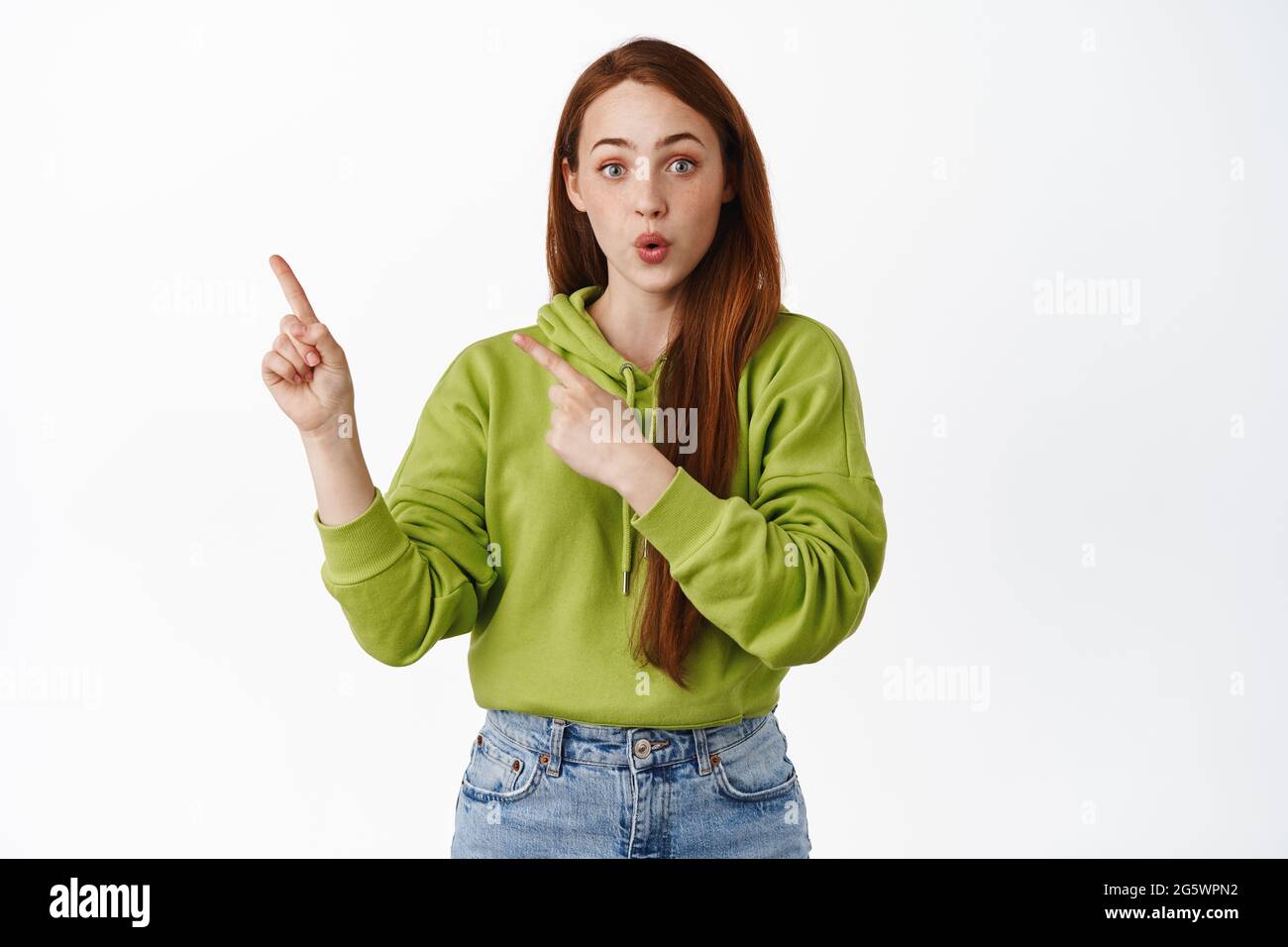 Wow awesome. Excited redhead girl gasp and look impressed, pointing ...