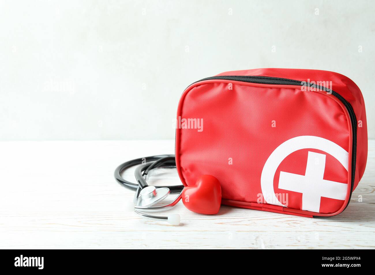 First aid medical kit on white wooden table Stock Photo - Alamy