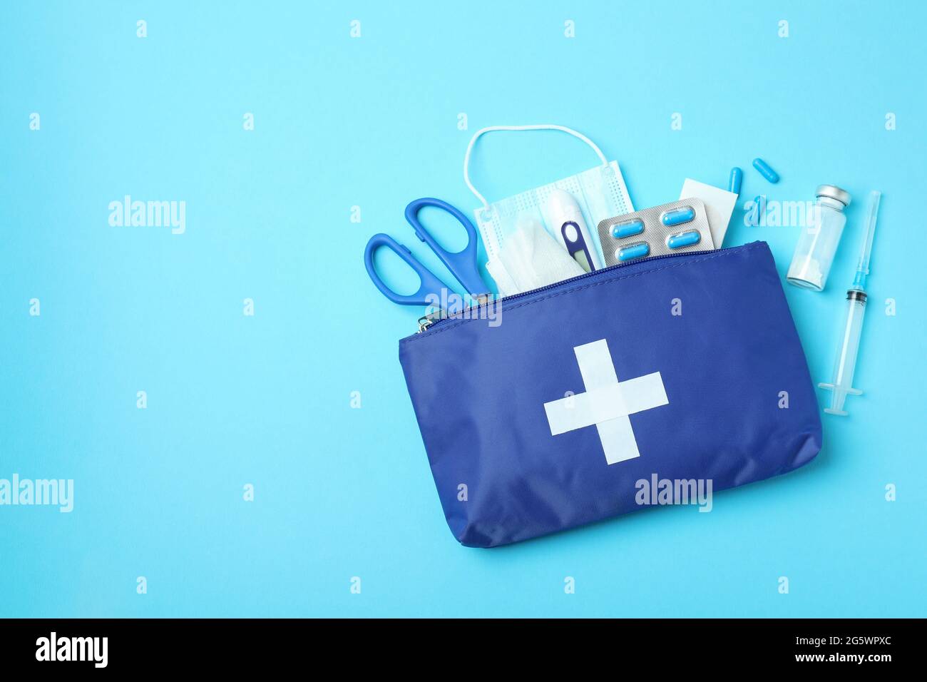 First aid medical kit on blue background Stock Photo - Alamy