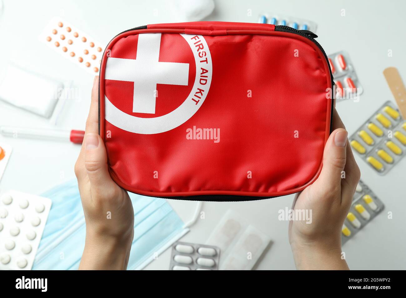 Female hands hold first aid medical kit on white background Stock Photo ...