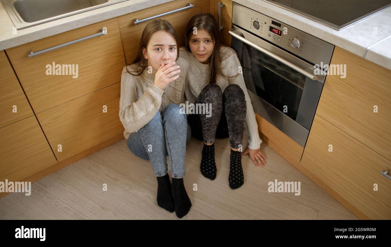 Two girls hiding from aggression or anger of parent. Concept of ...