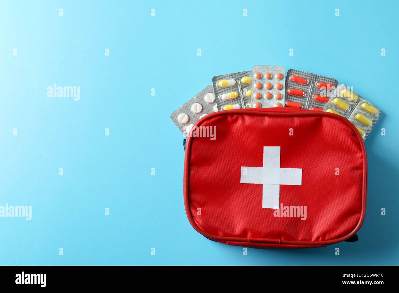 First aid medical kit on blue background Stock Photo - Alamy