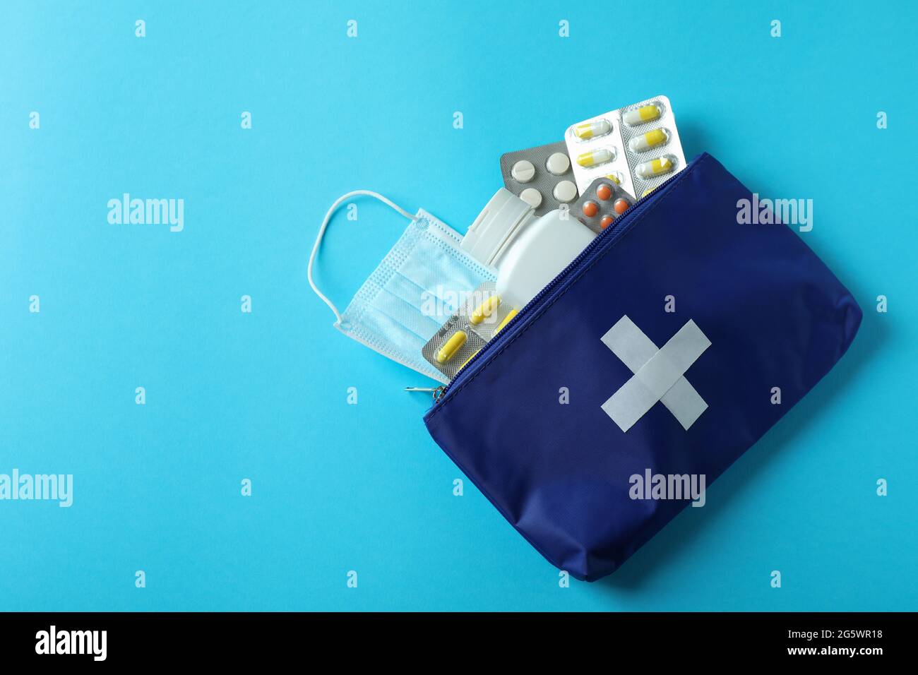 First aid medical kit on blue background Stock Photo - Alamy