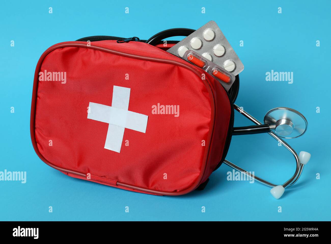 First aid medical kit on blue background Stock Photo - Alamy
