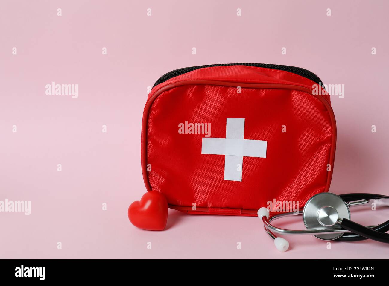 First aid medical kit on pink background Stock Photo - Alamy