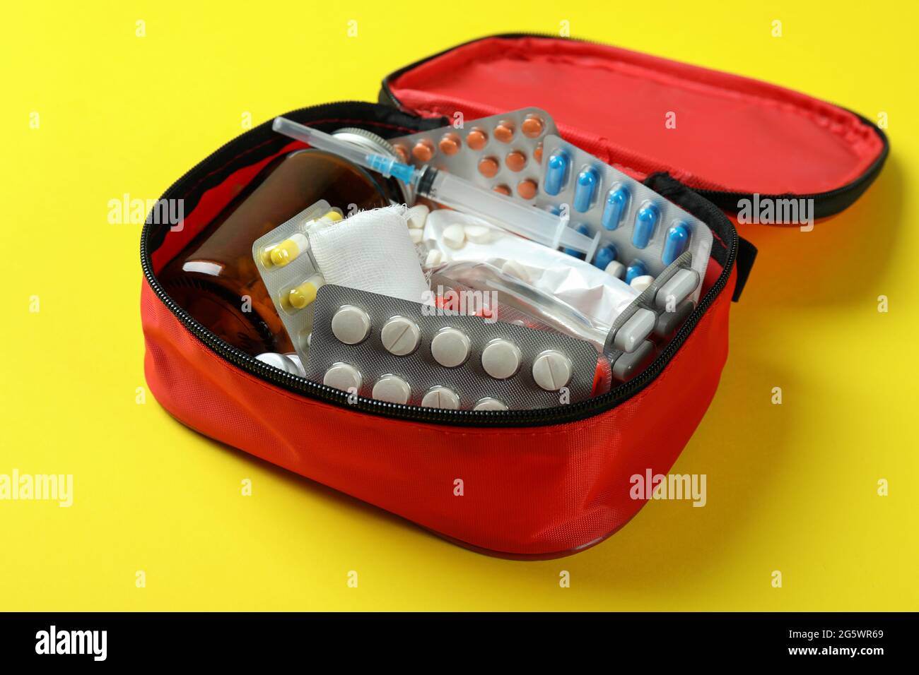 First aid medical kit on yellow background Stock Photo - Alamy