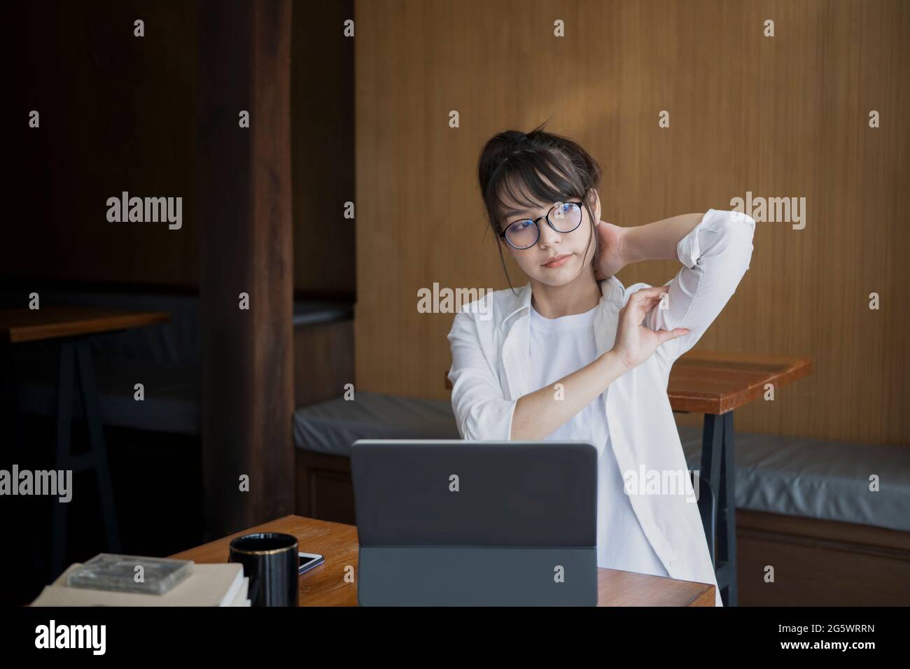 Female office worker relaxing at her workplace Stock Photo - Alamy