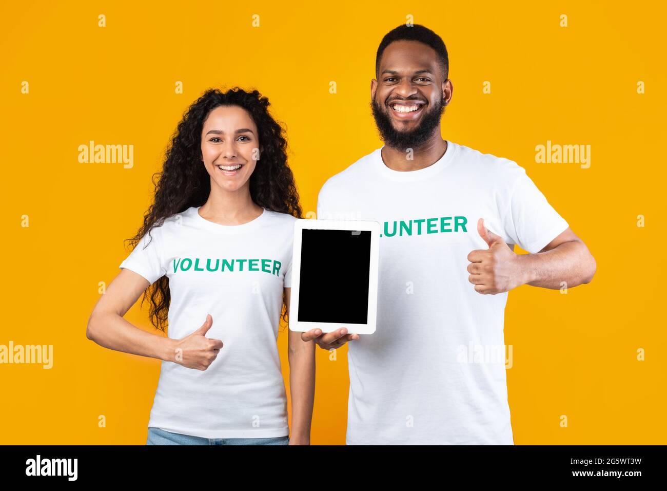 Volunteers Holding Tablet With Empty Screen Gesturing Thumbs-Up, Yellow ...
