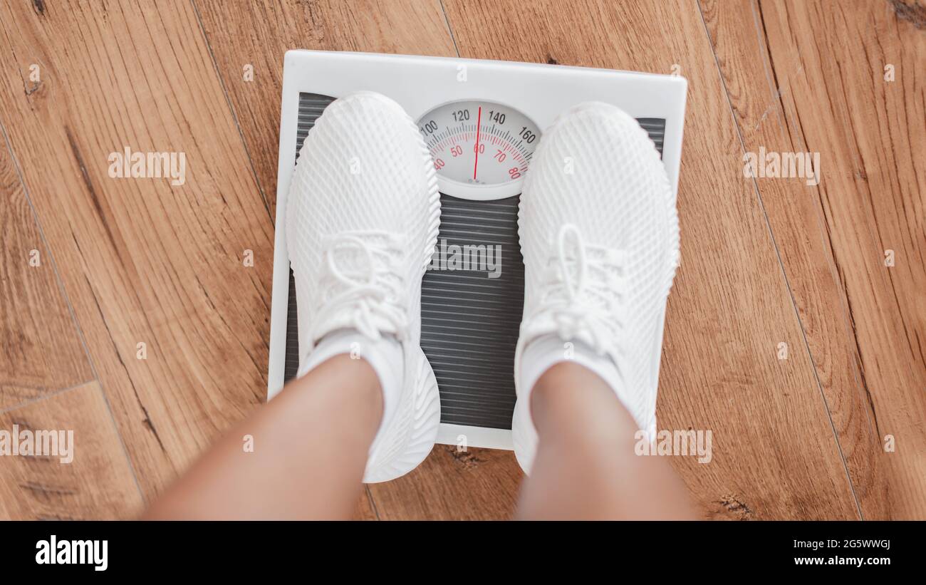 Overweight woman scales feet hi-res stock photography and images - Alamy