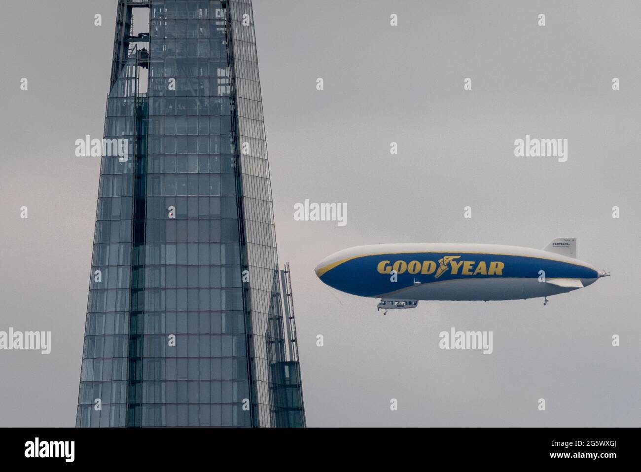 London, UK. 30th June 2021. The Goodyear Blimp is seen drifting over ...