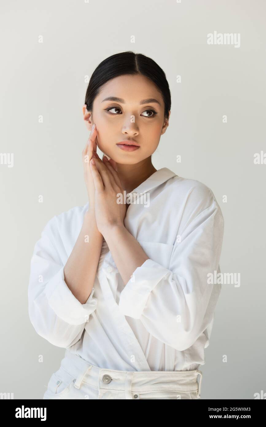 Pretty japanese woman posing isolated on grey Stock Photo - Alamy