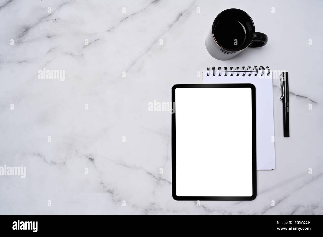Mock up digital table with empty display, notebook and coffee cup on ...