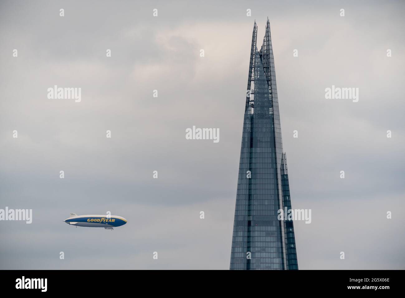 London, UK. 30th June 2021. The Goodyear Blimp is seen drifting over ...