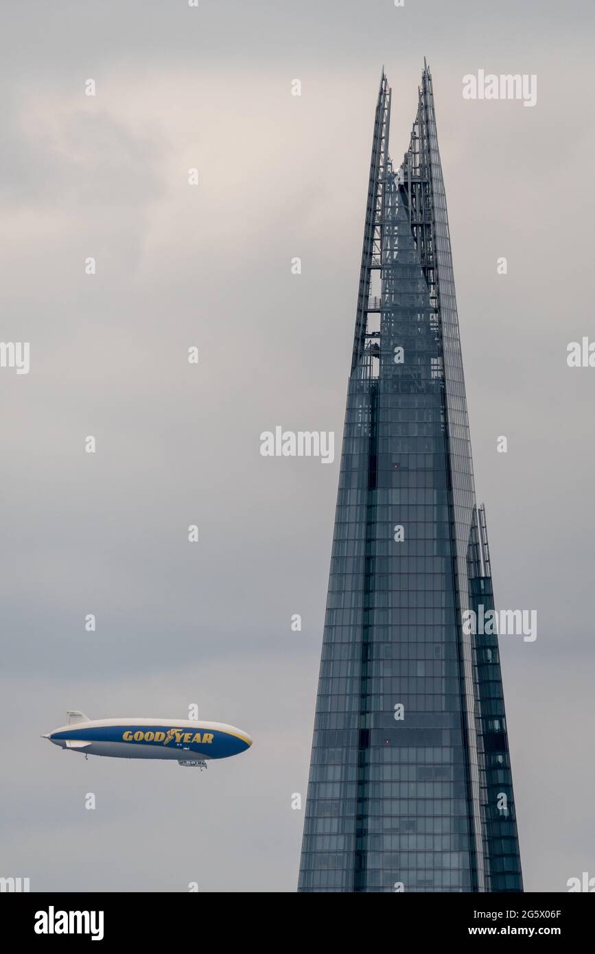 London, UK. 30th June 2021. The Goodyear Blimp is seen drifting over ...