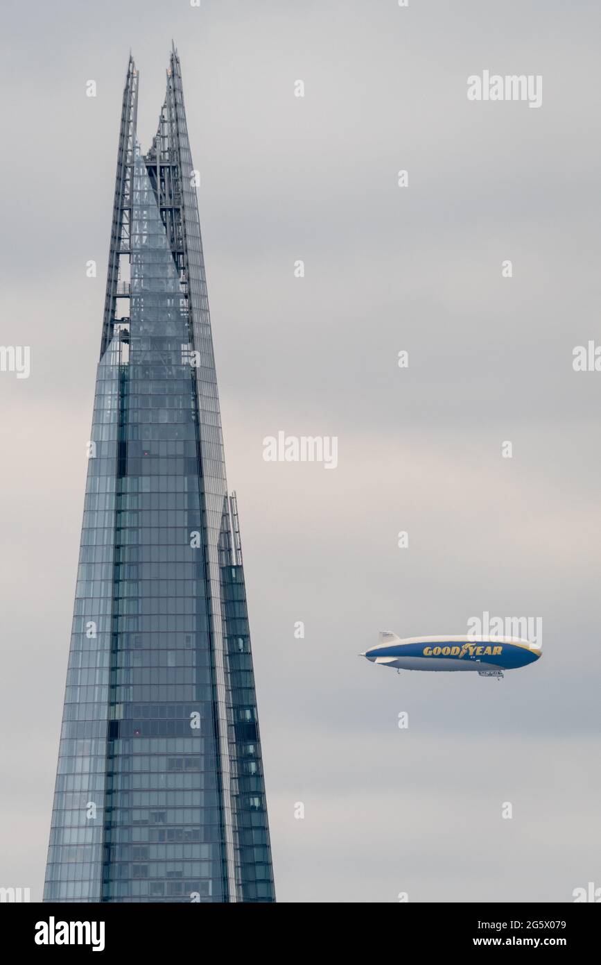 London, UK. 30th June 2021. The Goodyear Blimp is seen drifting over ...
