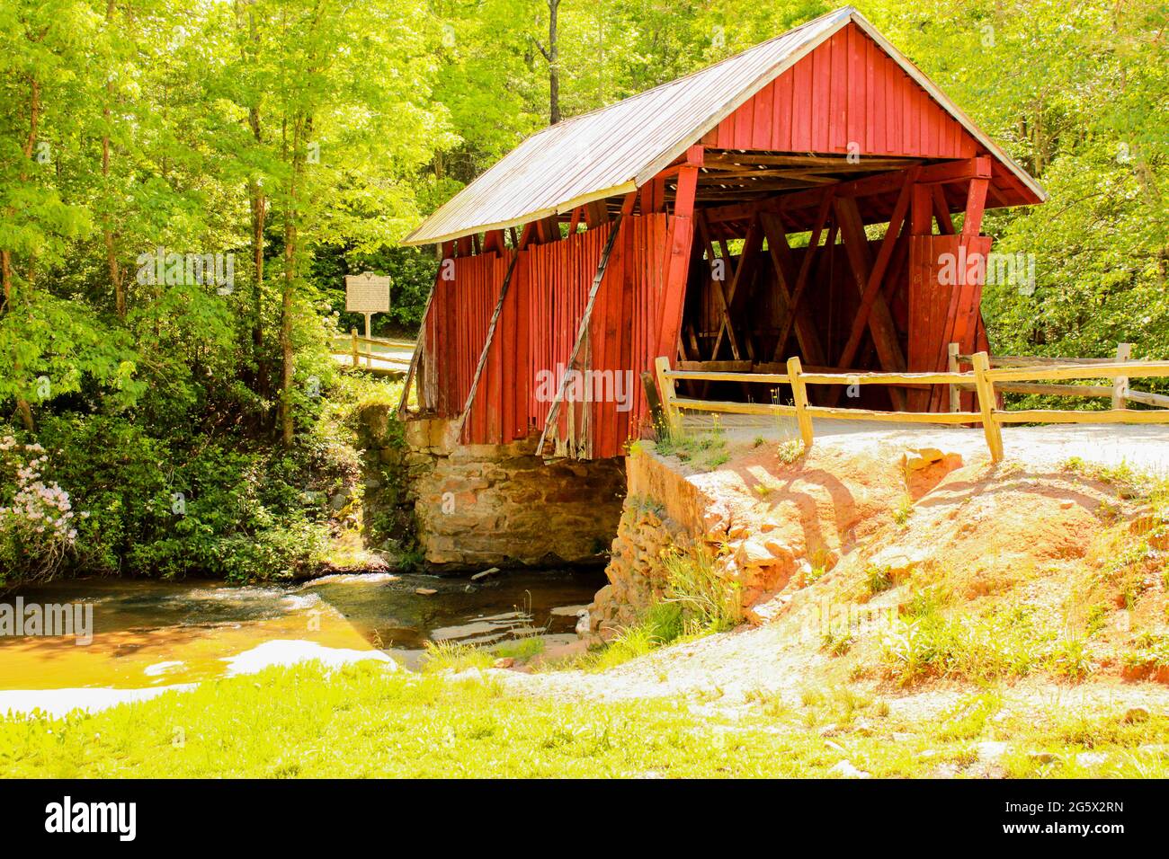 Red Covered Bridge In The Water Stock Photo - Alamy