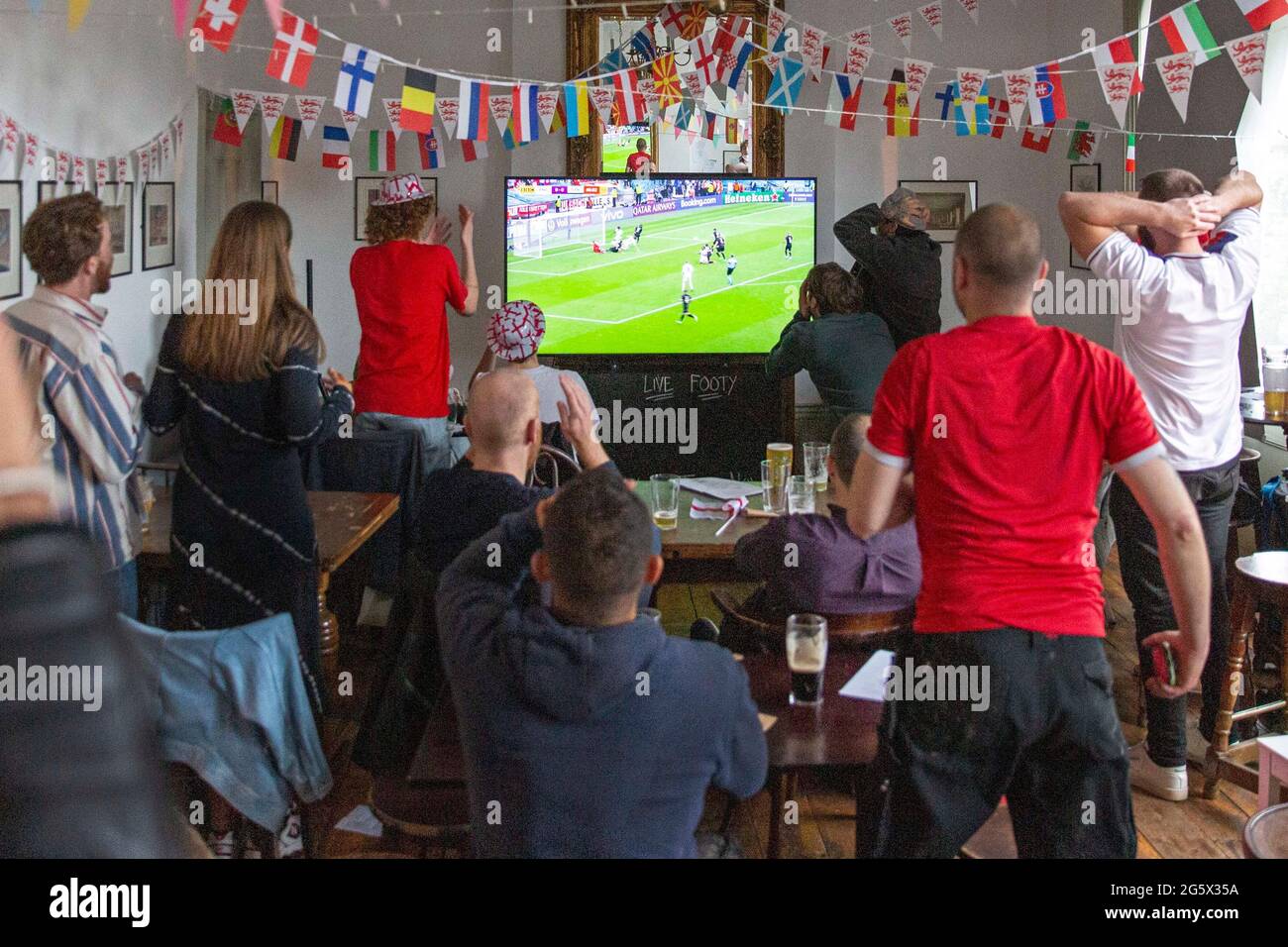 England fans celebrate beating Germany in The Prince George pub in East ...