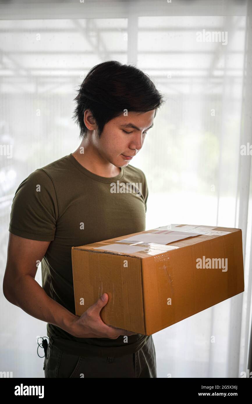 Business owner holding product packaging cardboard box Stock Photo - Alamy