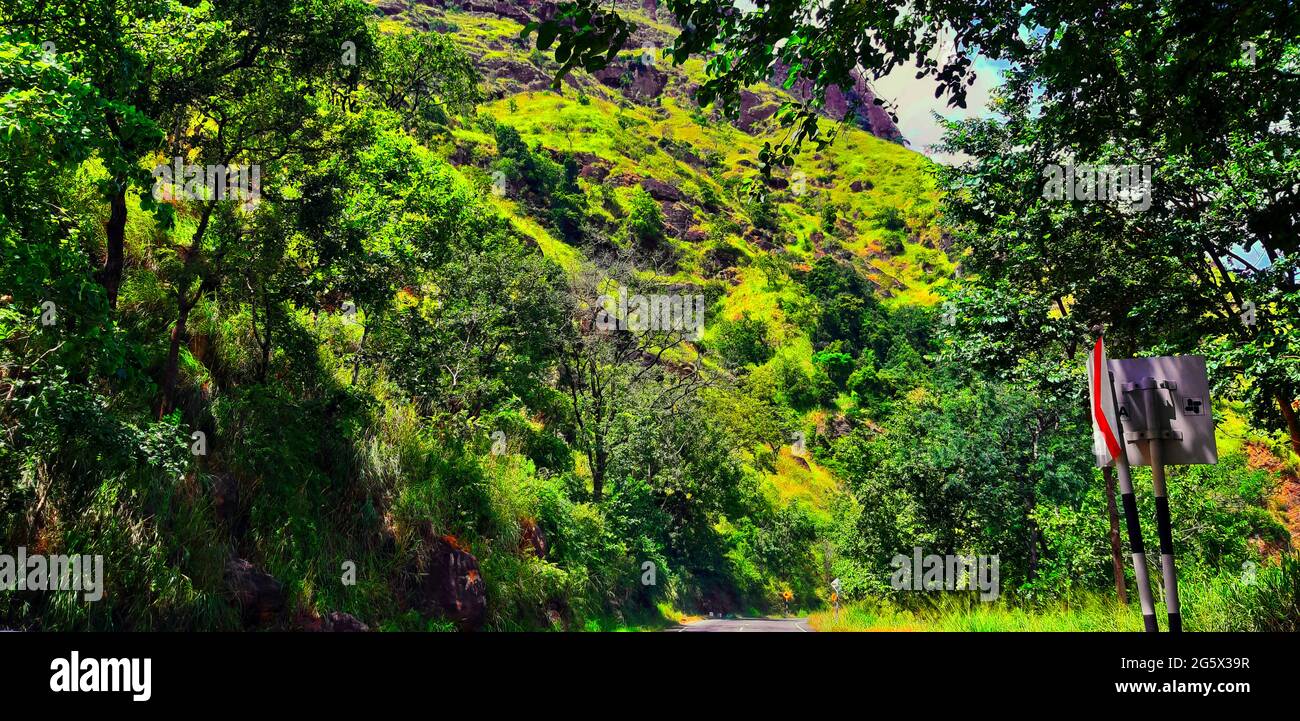 road symbol with mountain in the main road Stock Photo - Alamy