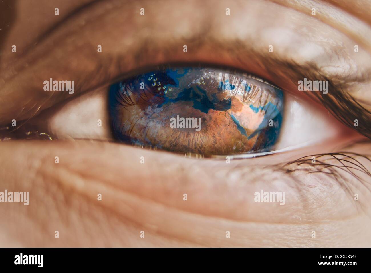 Close-up of planet earth in the eye of a child. View of a child on the ...