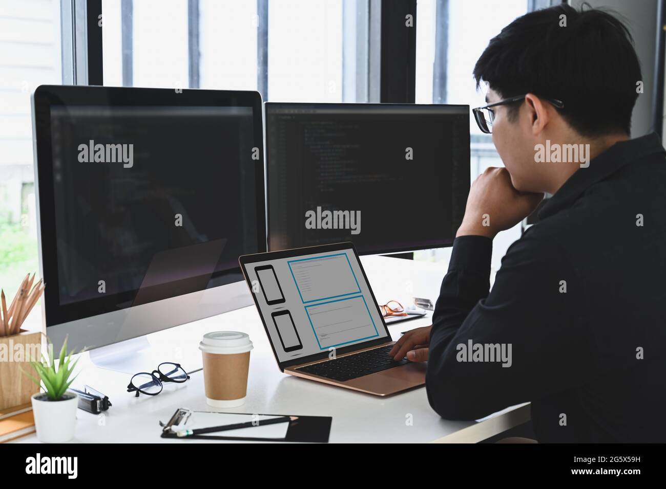 Young programmer working on new project at modern office Stock Photo ...