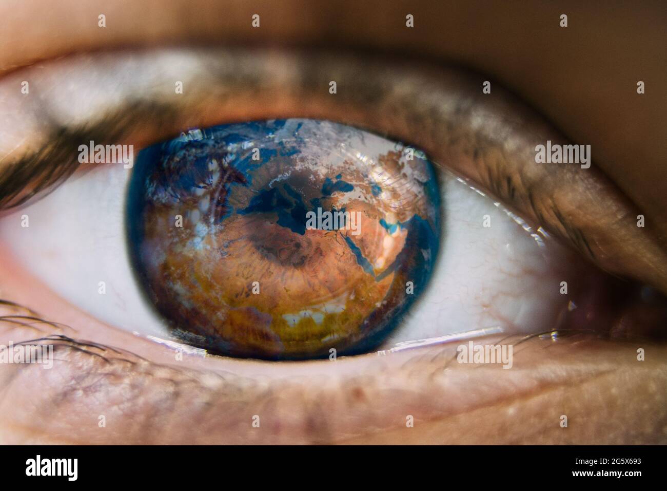 Close-up of planet earth in the eye of a child. View of a child on the ...