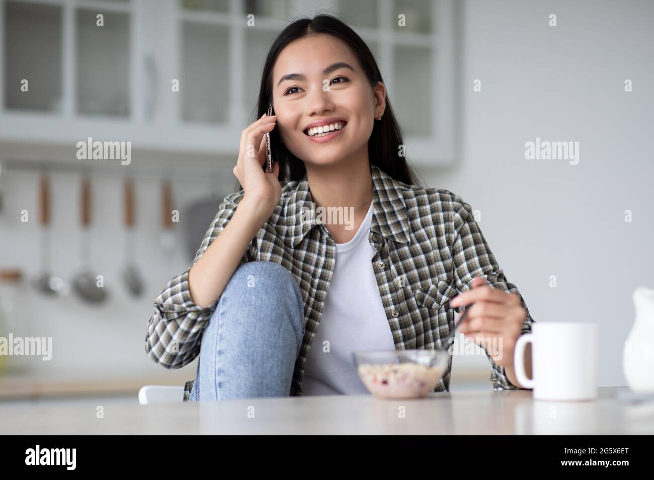 Happy asian woman calling boyfriend while having breakfast Stock Photo ...
