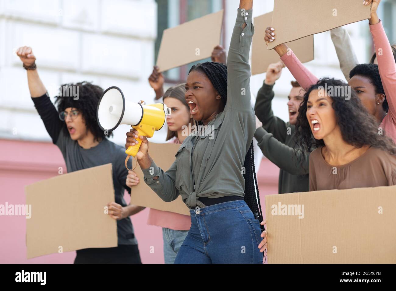 Motivated african american woman with loudspeaker over crowd Stock ...
