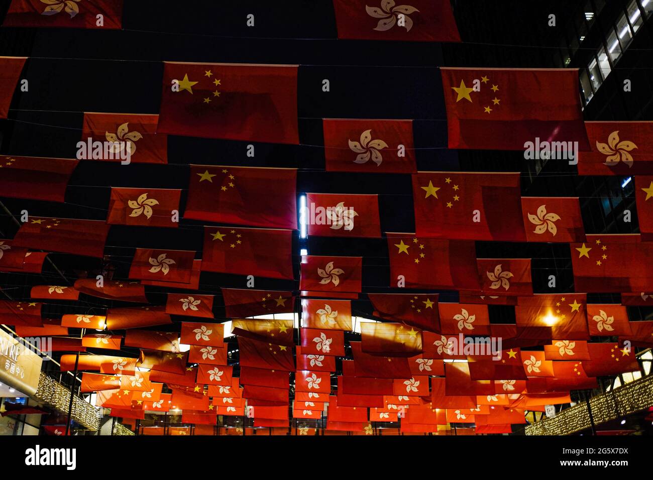 Hong Kong, China. 30th June, 2021. China and Hong Kong SAR flags are ...