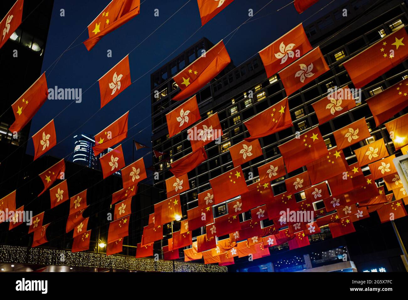 Hong Kong, China. 30th June, 2021. China and Hong Kong SAR flags are ...
