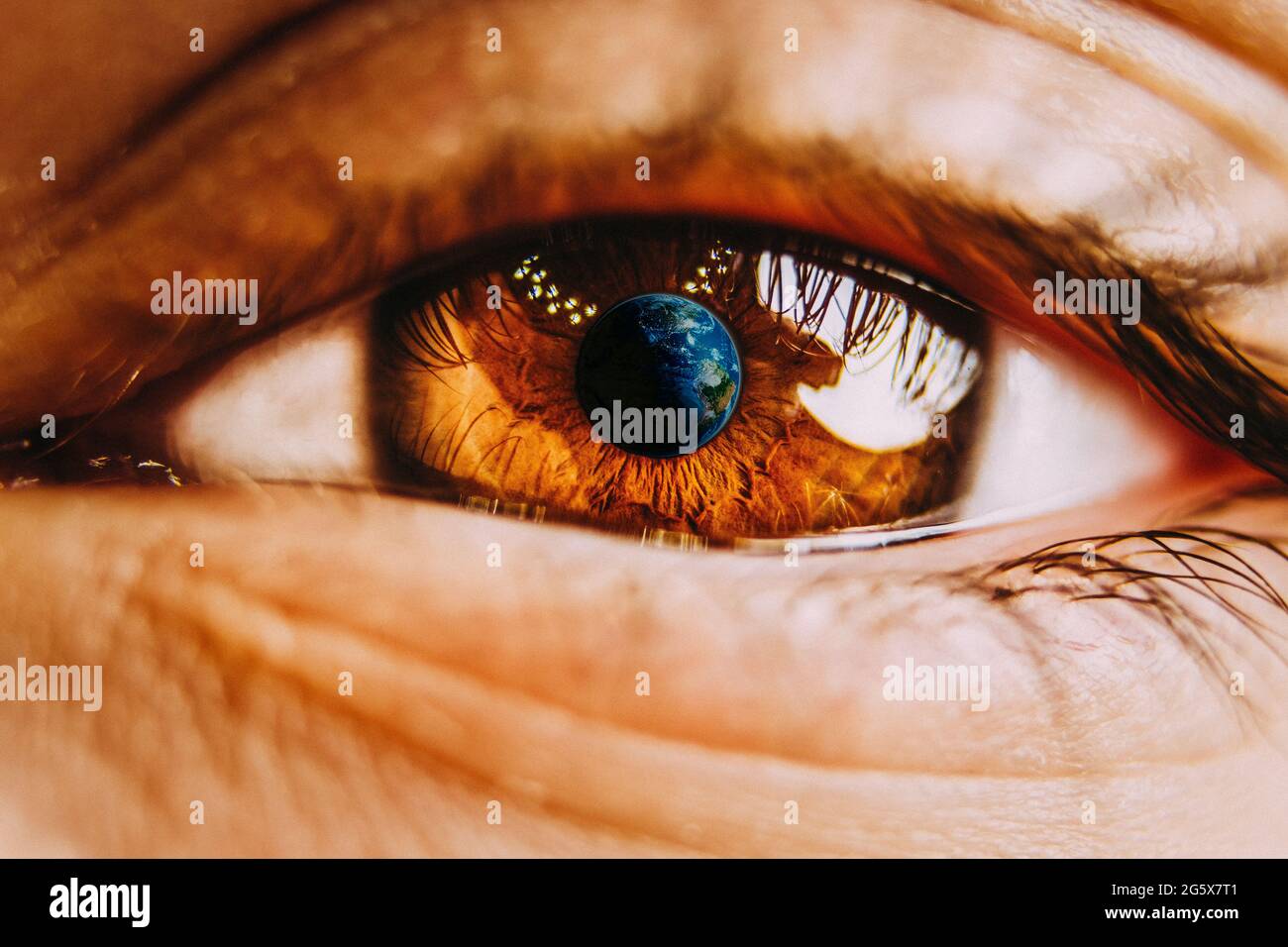 Close-up of planet earth in the eye of a child. View of a child on the ...