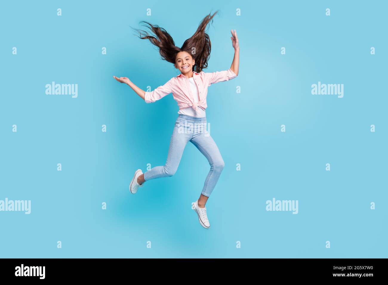 Full size photo of energetic cheerful school person jumping hair flying ...