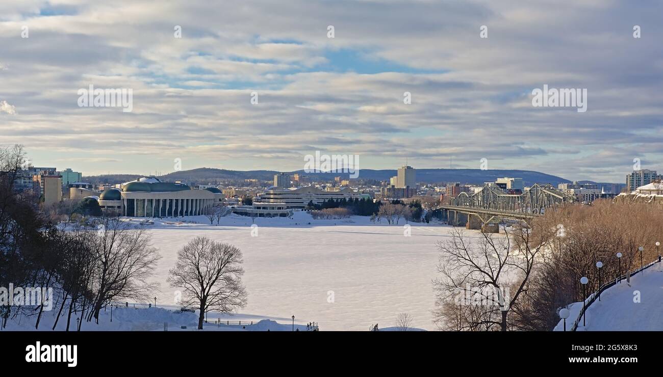 Hull island along frozen Ottawa river, with highrise office buildings ...