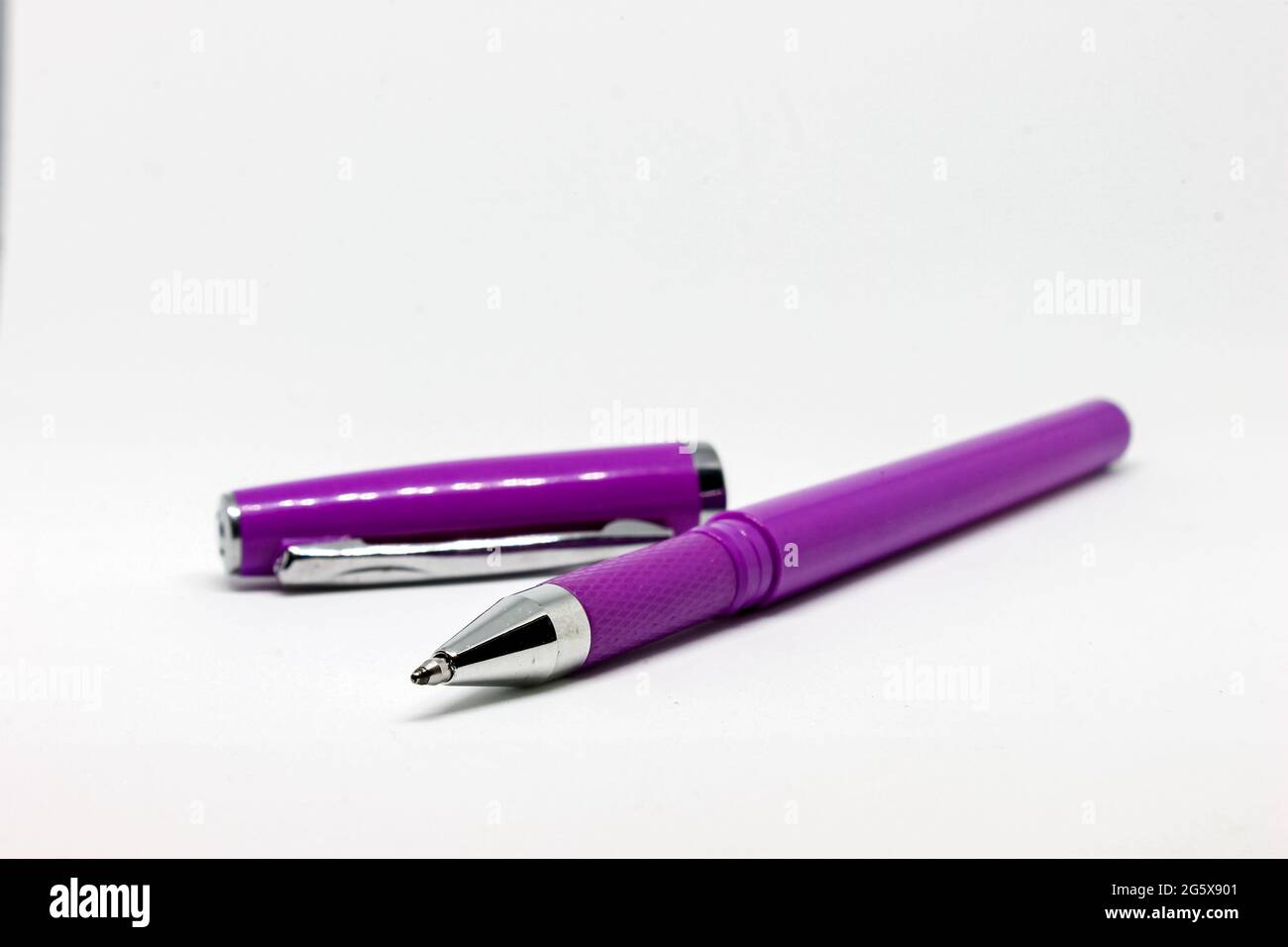 Purple pen on white background Stock Photo - Alamy