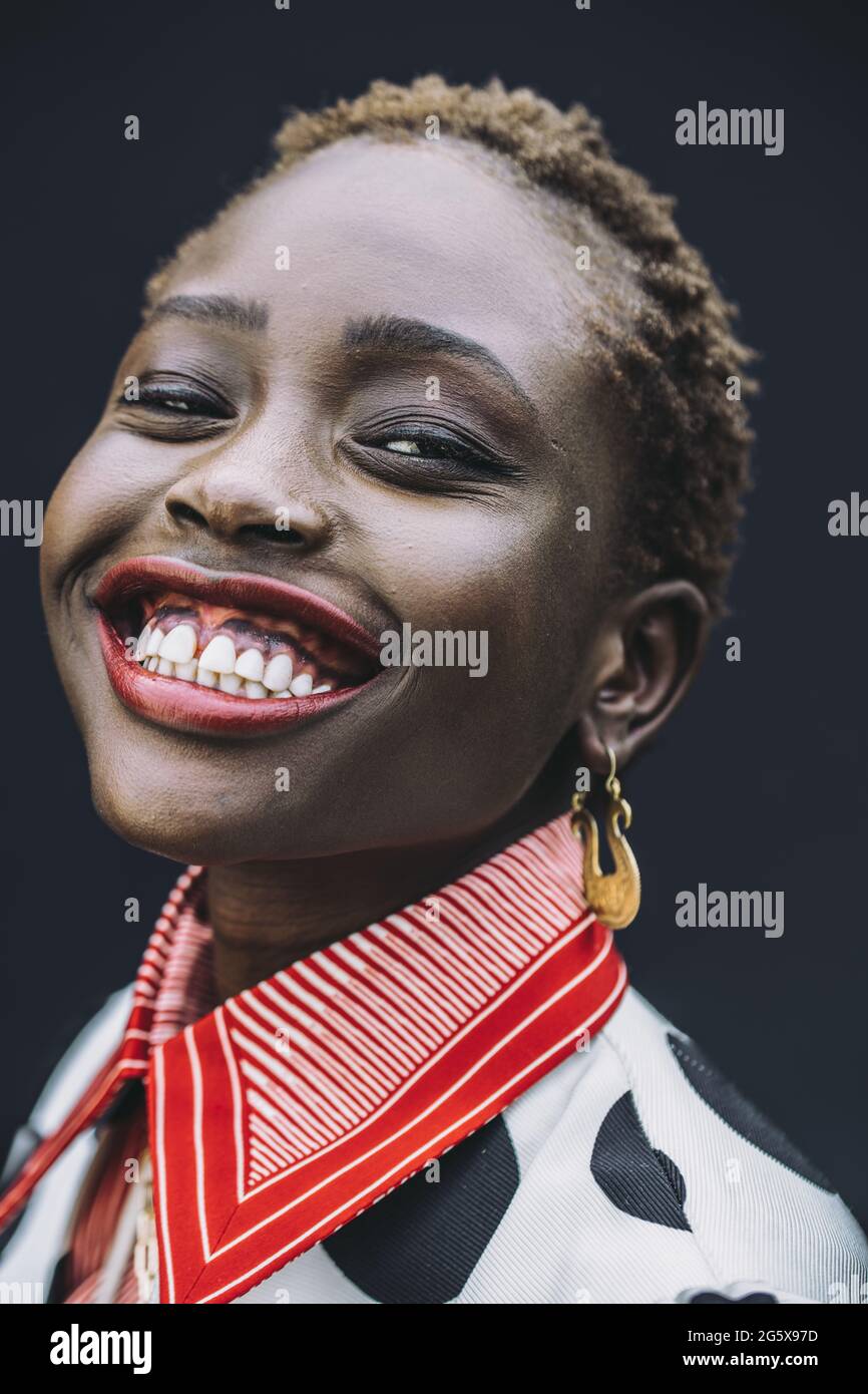 Beautiful African model with black skin against a dark background ...