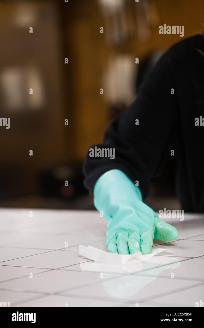 Disinfecting surfaces from bacteria or Covid-19, hand with glove ...