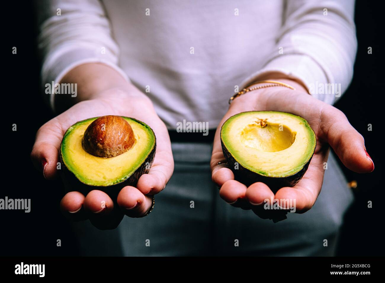 Avocado hand hi-res stock photography and images - Alamy