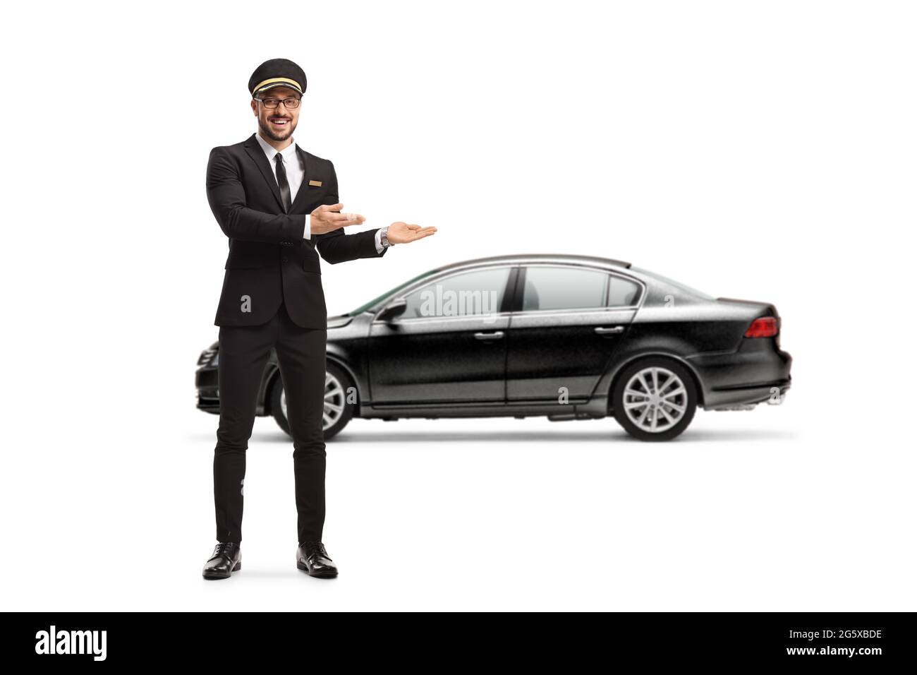 Full length portrait of a professional chauffeur pointing at a black ...