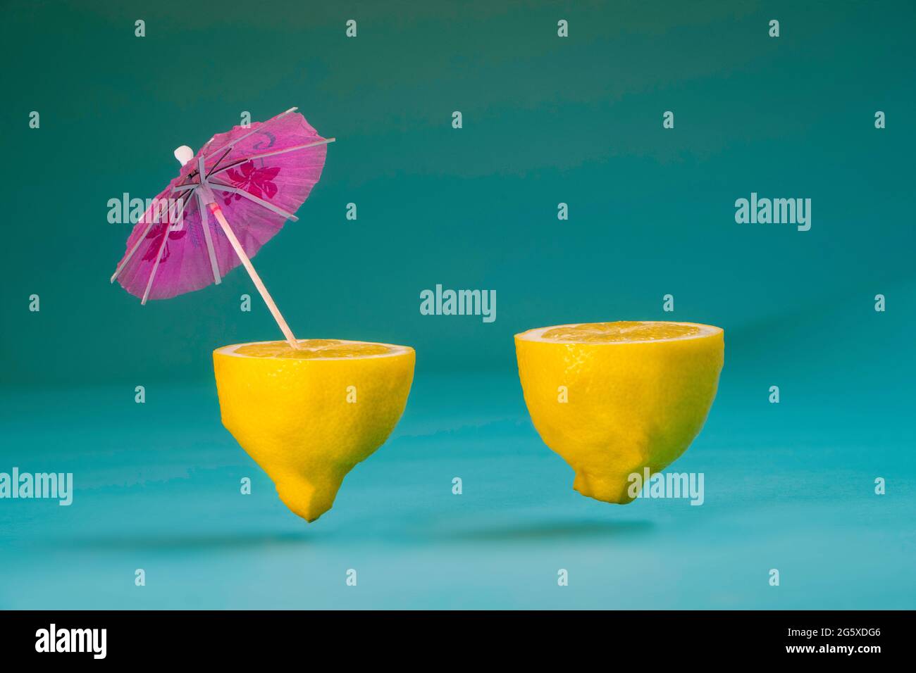 Tropical summer background. Slices of lemon levitating on a blue ...