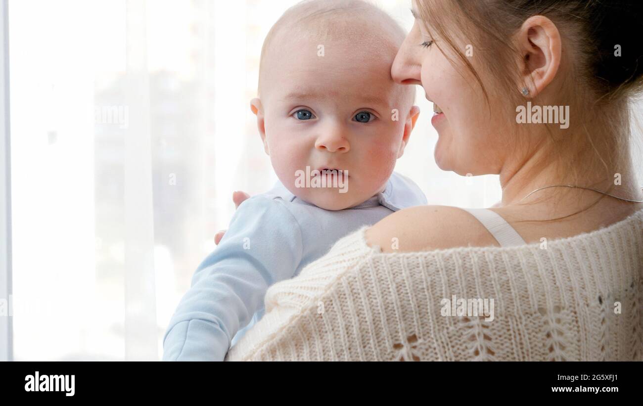 Closeup portrait of baby and mother face hugging and embracing at big ...