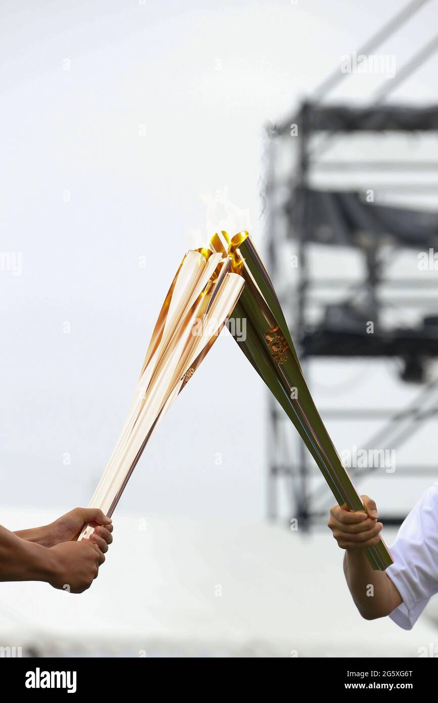 Passing of the olympic flame at the Tokyo 2020 Olympic Torch Relay held ...