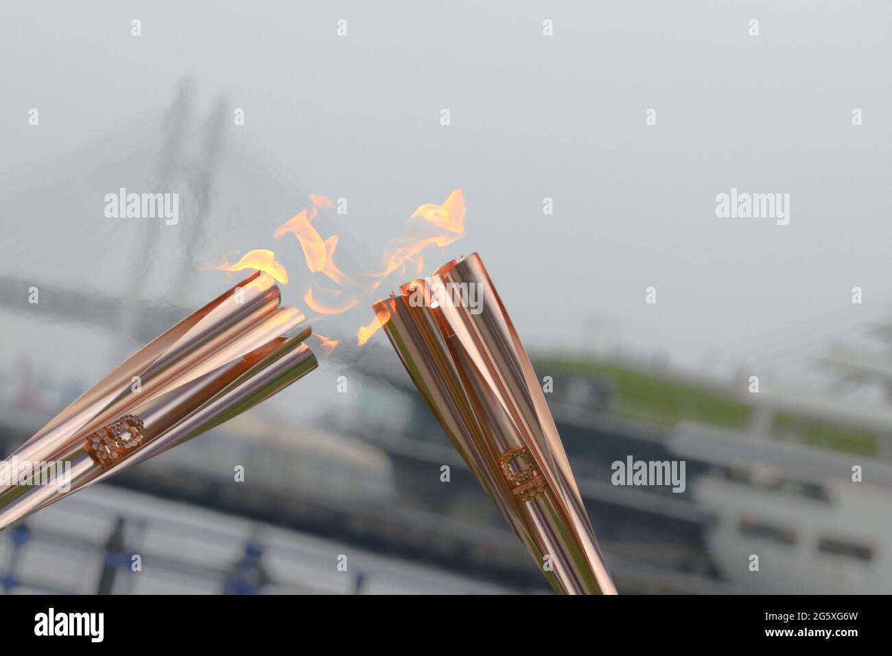 Passing of the olympic flame at the Tokyo 2020 Olympic Torch Relay held ...