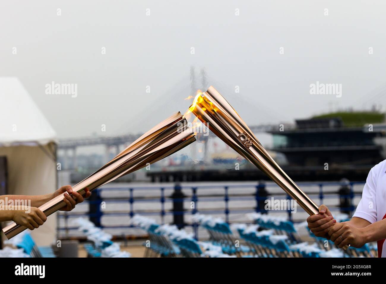 Passing of the olympic flame at the Tokyo 2020 Olympic Torch Relay held ...