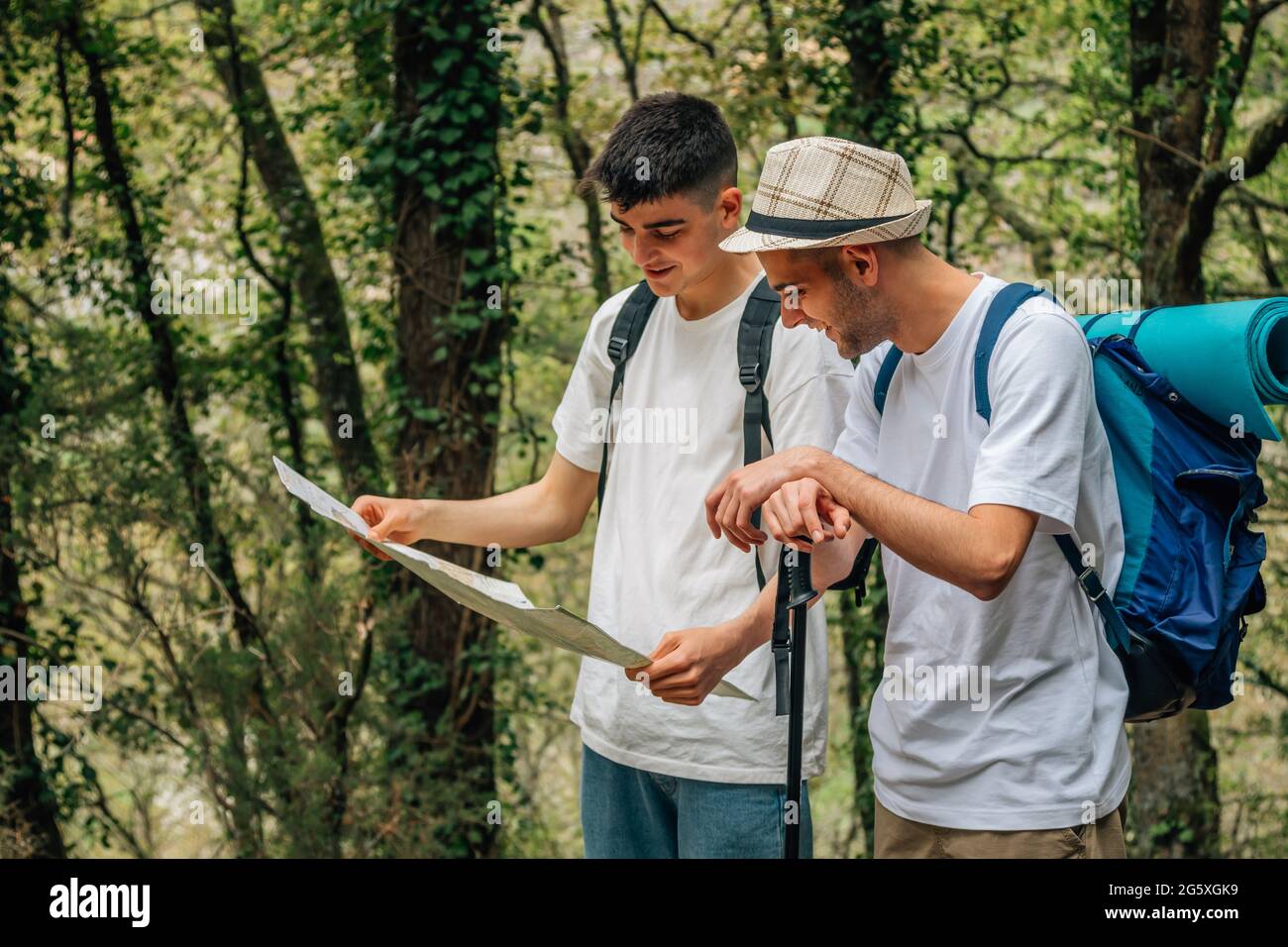 young people traveling with excursion or hiking map Stock Photo - Alamy