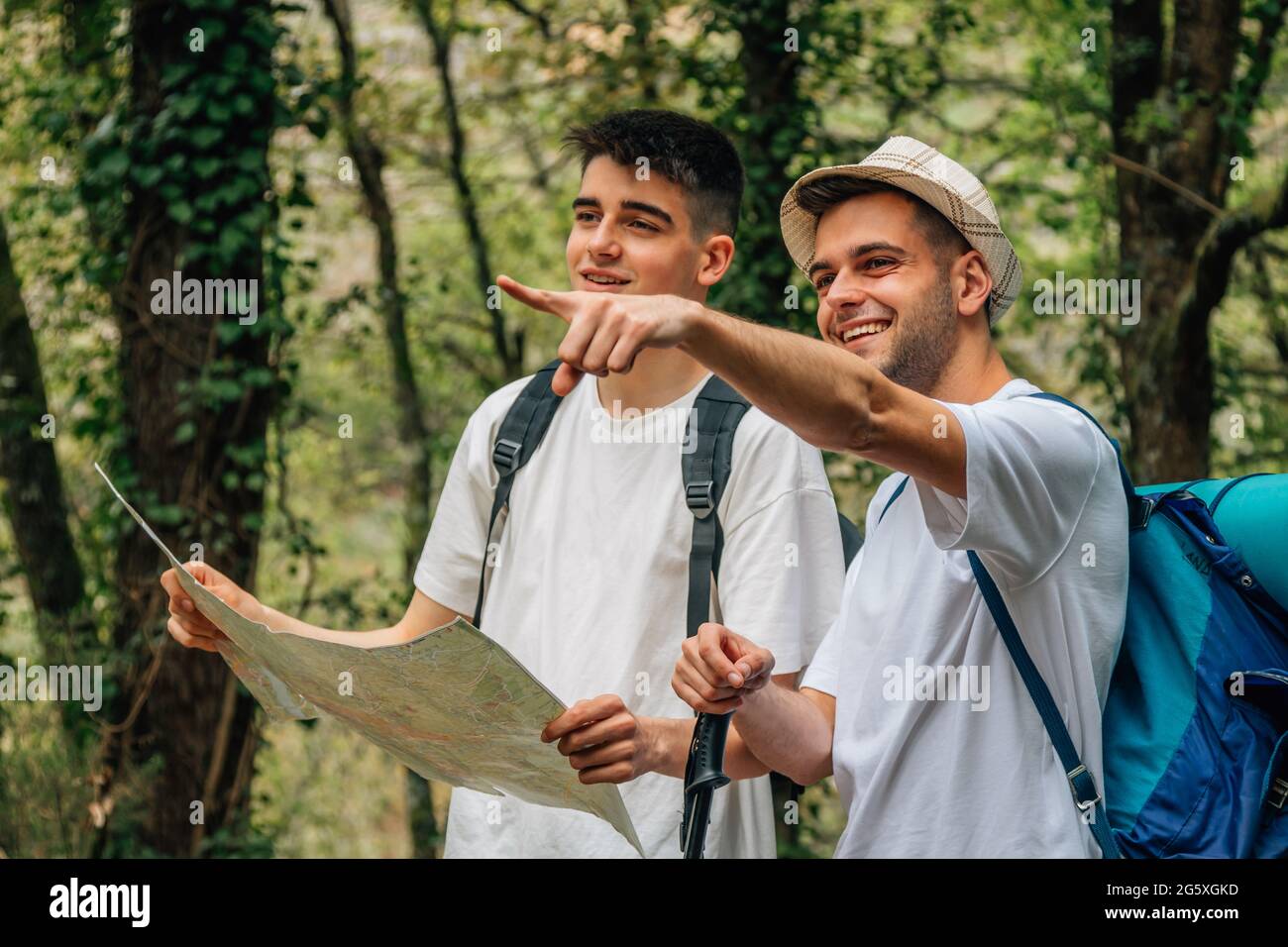 young people traveling with excursion or hiking map Stock Photo - Alamy